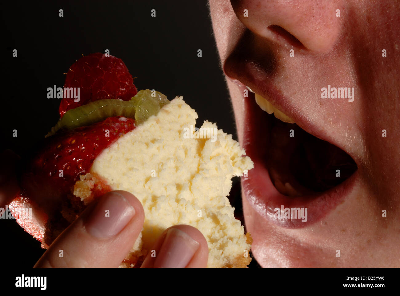 A woman prepares to eat a slice of cheese cake Stock Photo - Alamy