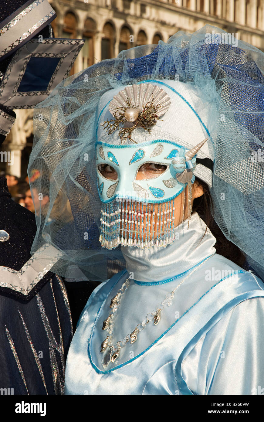 Girl wearing a light blue disguise with pearl and shells during Venice ...