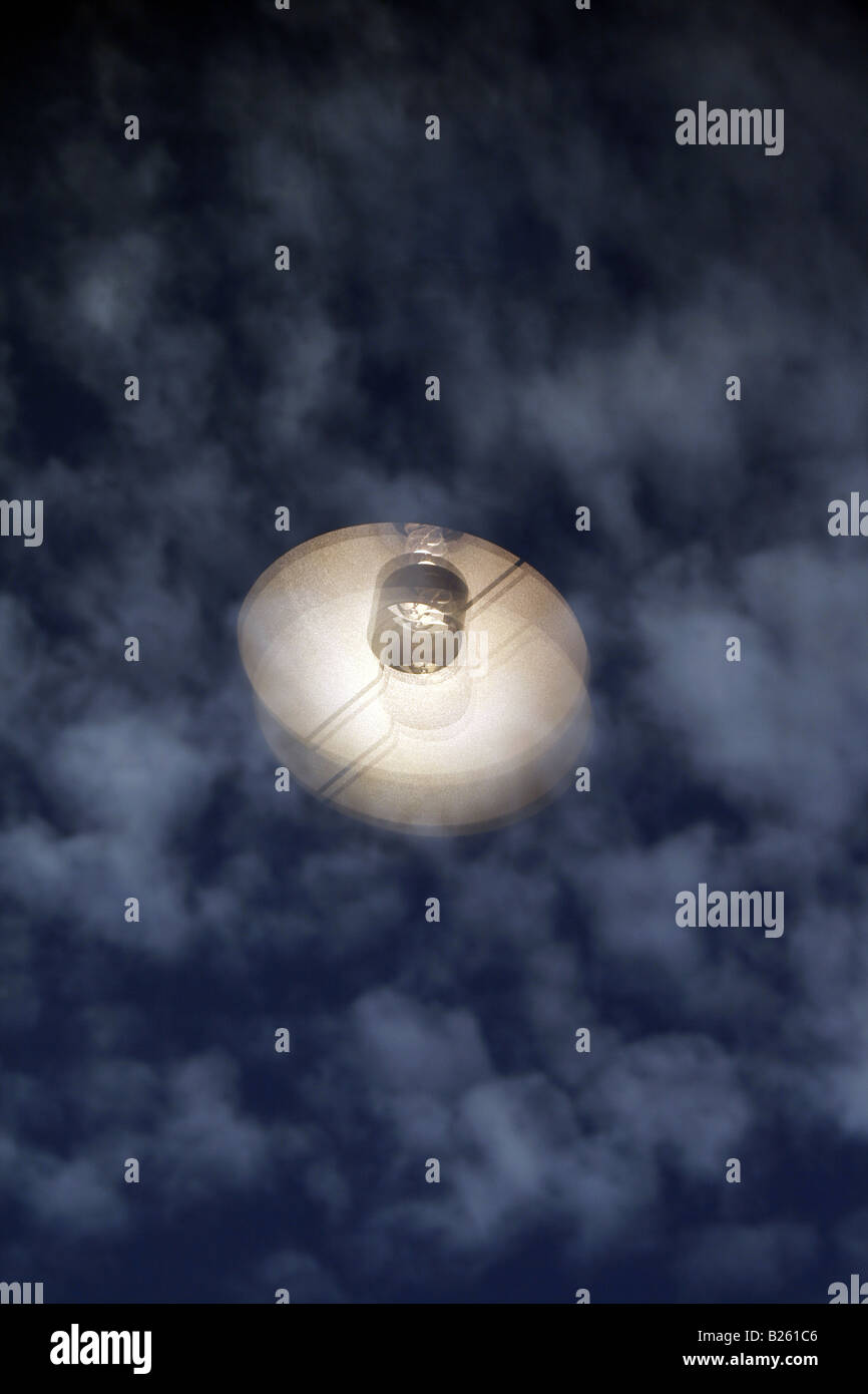 one light bulb reflection on glass window with white clouds and blue ...