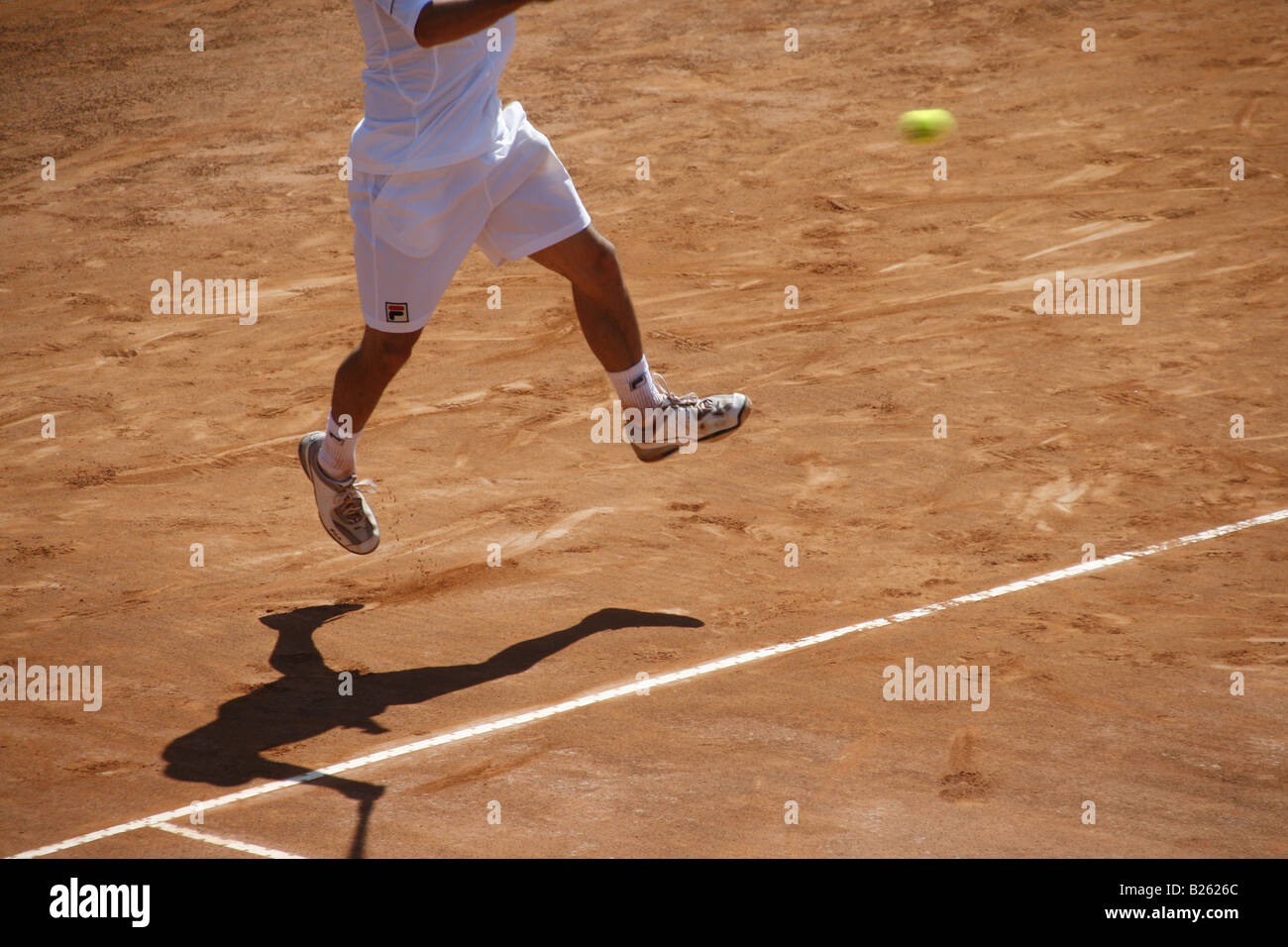 one male tennis player in action on court Stock Photo - Alamy