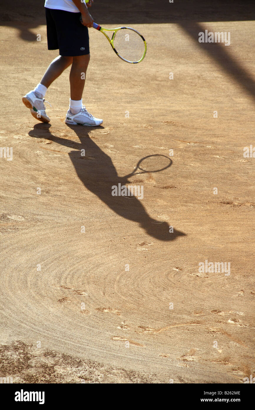shadow of tennis player in action on court Stock Photo - Alamy