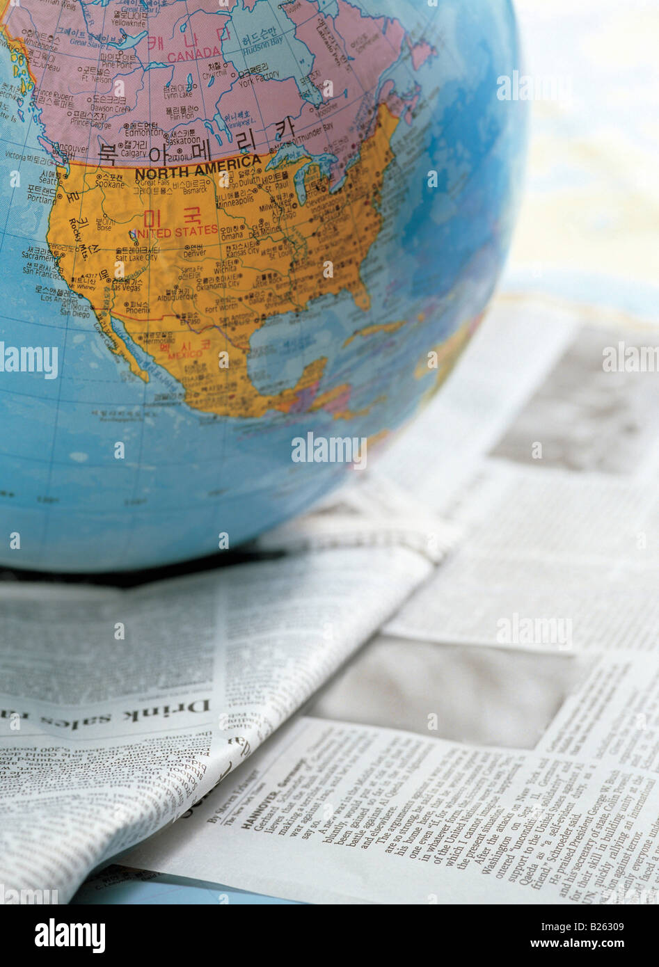 Globe on newspaper Stock Photo - Alamy