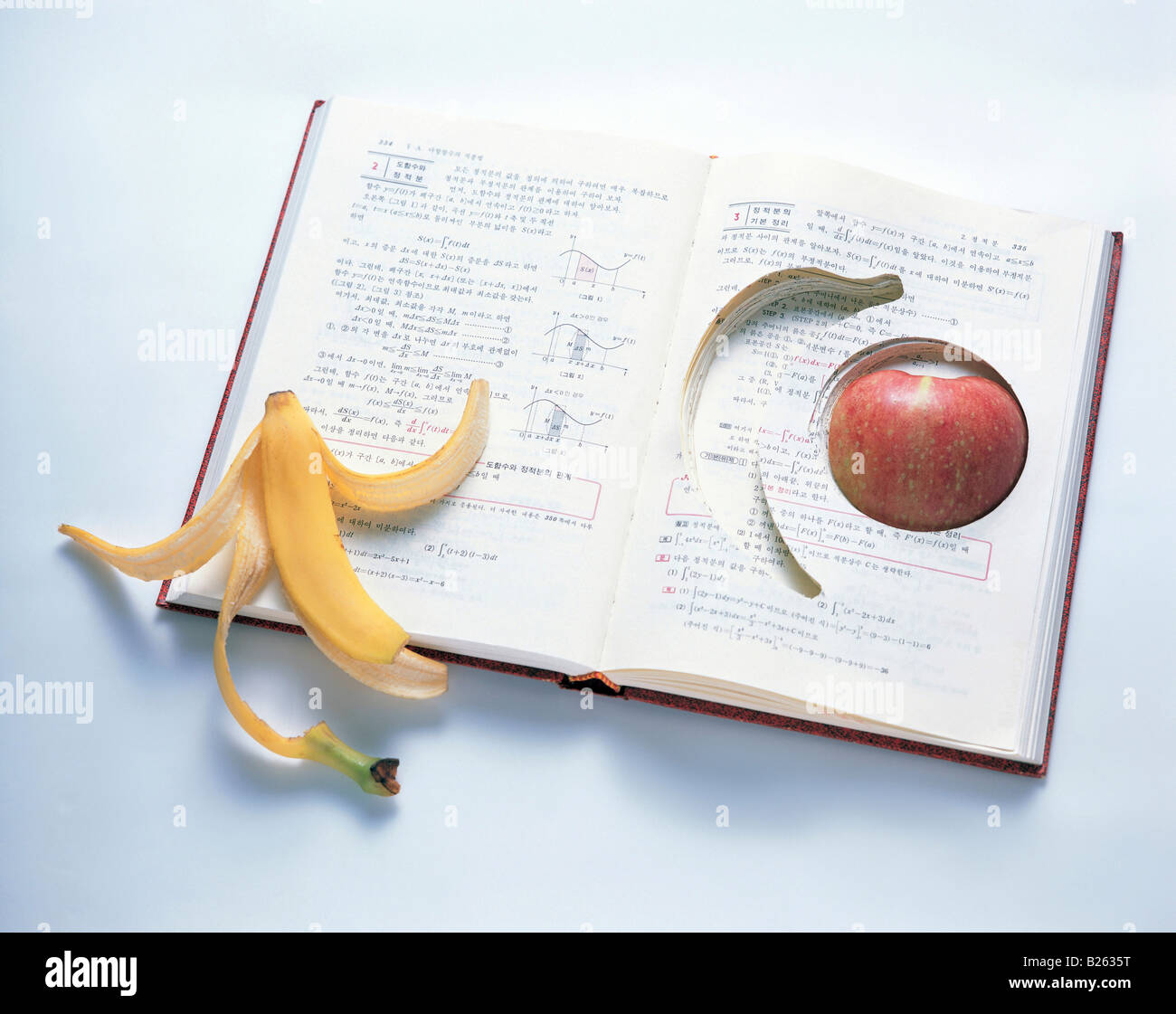 Banana, apple and book Stock Photo - Alamy