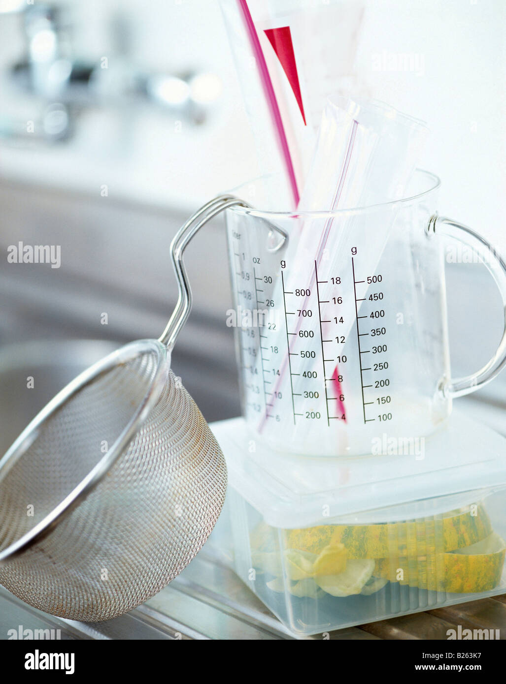 Measuring glass and filter in kitchen Stock Photo - Alamy