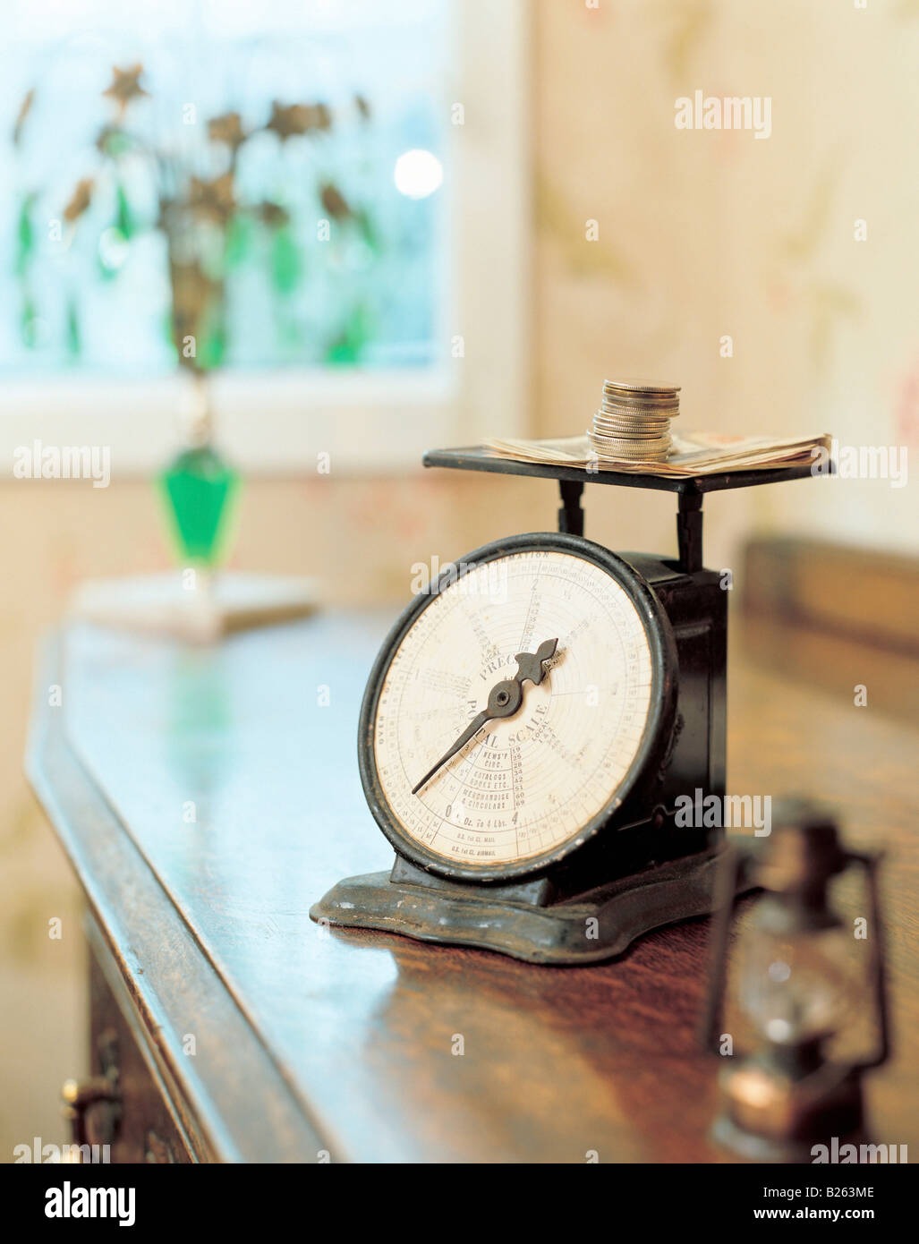Coins on kitchen scale Stock Photo - Alamy