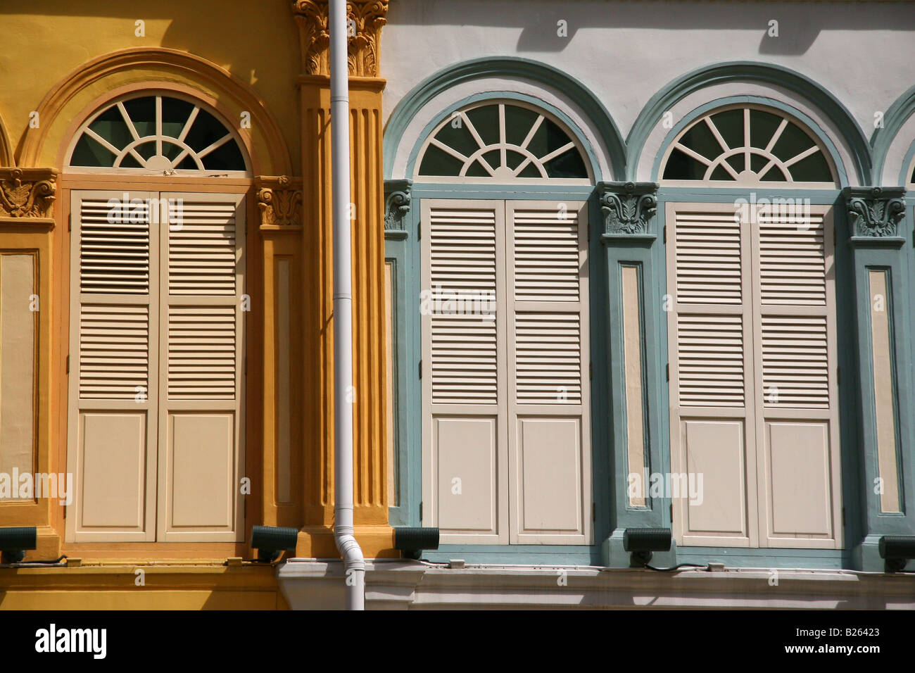 Traditional arched and shuttered windows of Colonial period buildings ...