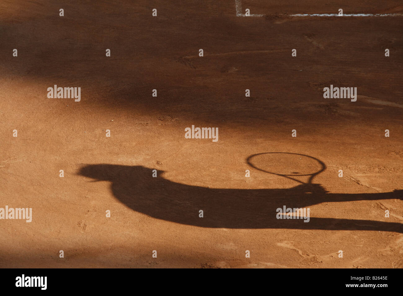 shadow of tennis player in action on court Stock Photo - Alamy