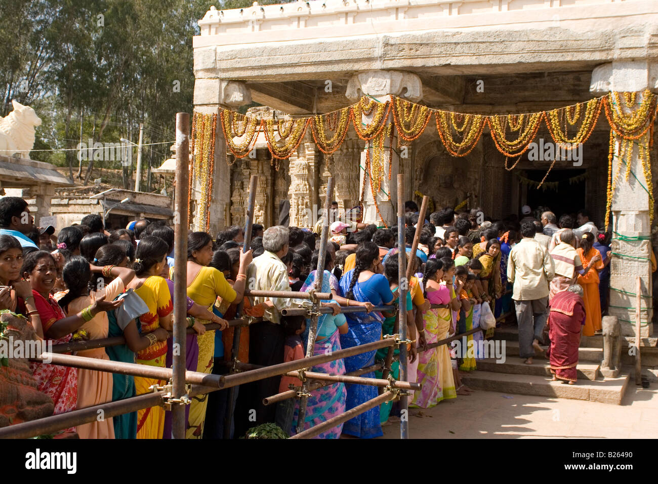 People queue to enter one of the temples containing the sacred Lingam ...