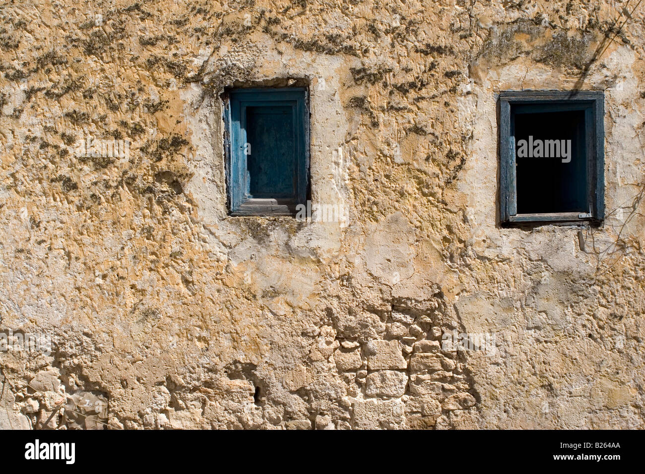 A wall in Apulia, Italy. The blue window frames sit inside of a ...