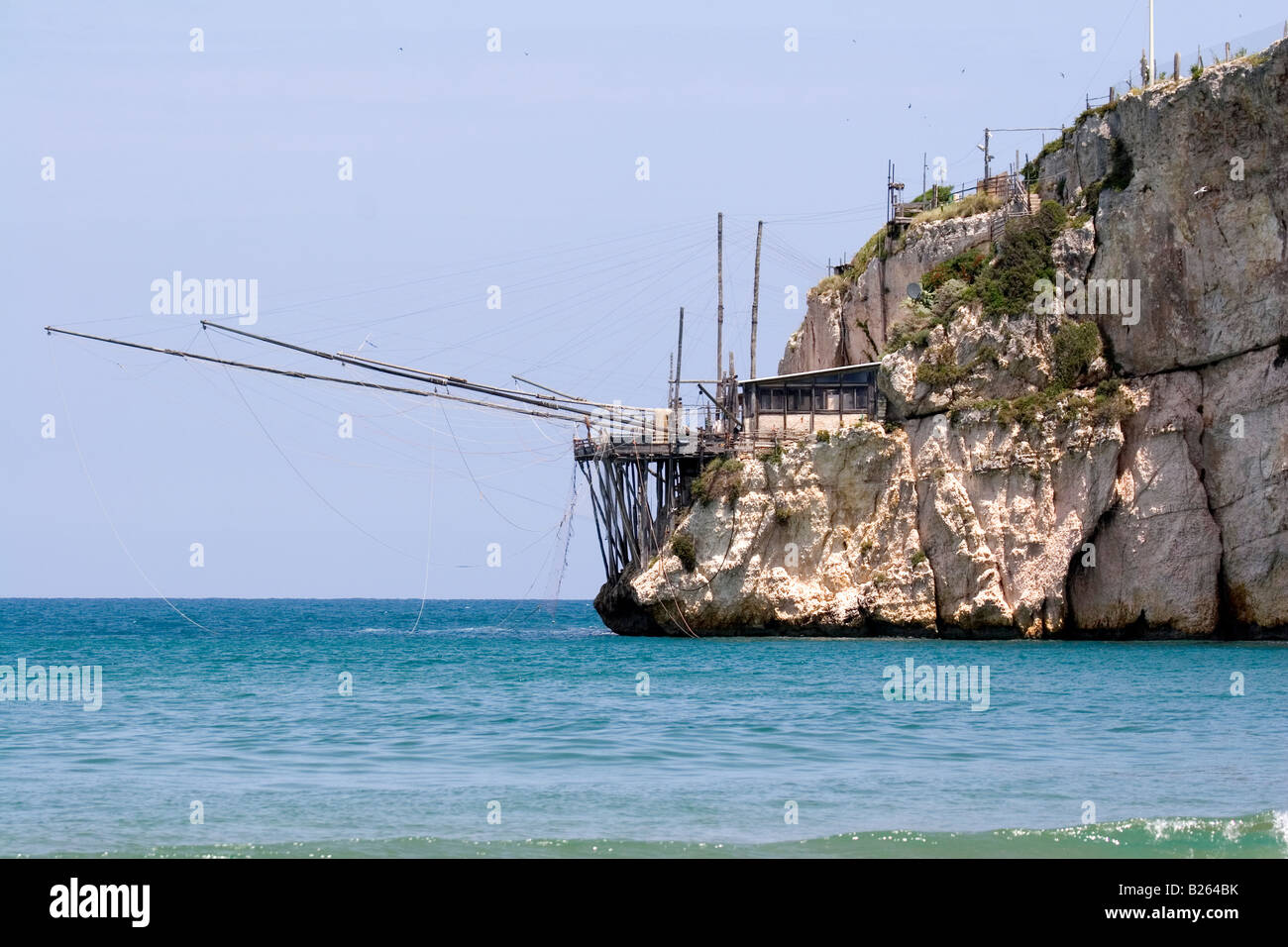 Fishing rods extend from a cliff in the Gargano area of Apulia, Italy ...