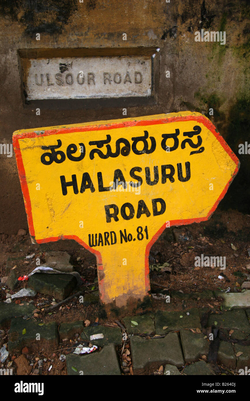 Two road signs show the old and new names for a Ulsoor/Halasuru Road in ...