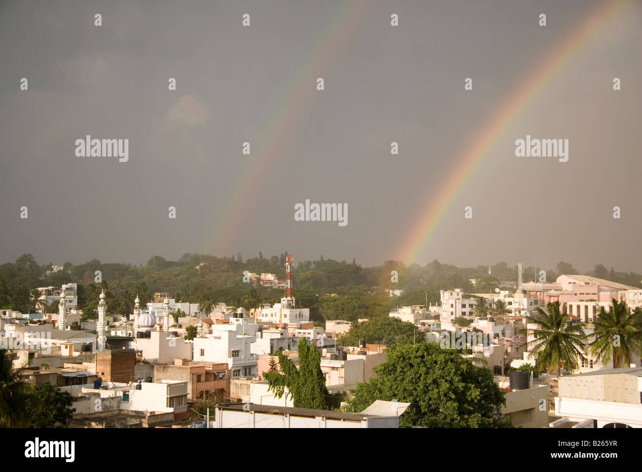 A rainbow over houses in Bangalore, India. Rainbows are not an uncommon ...