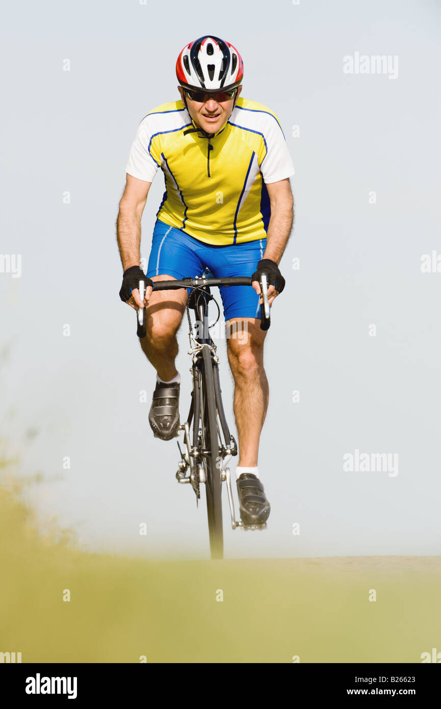 Cyclist riding bicycle, front view Stock Photo - Alamy