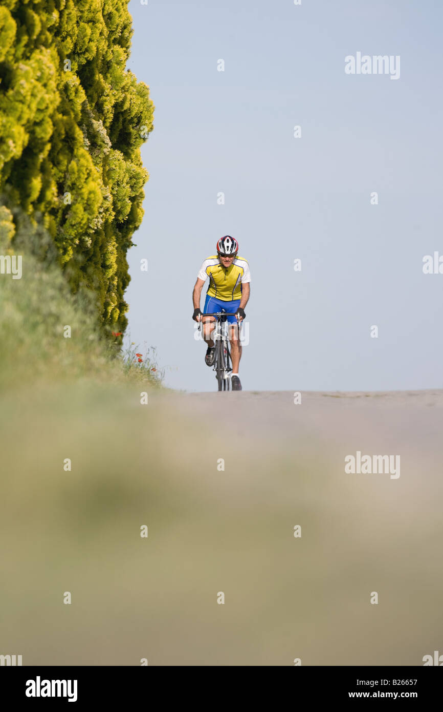 Cyclist riding bicycle, front view Stock Photo - Alamy