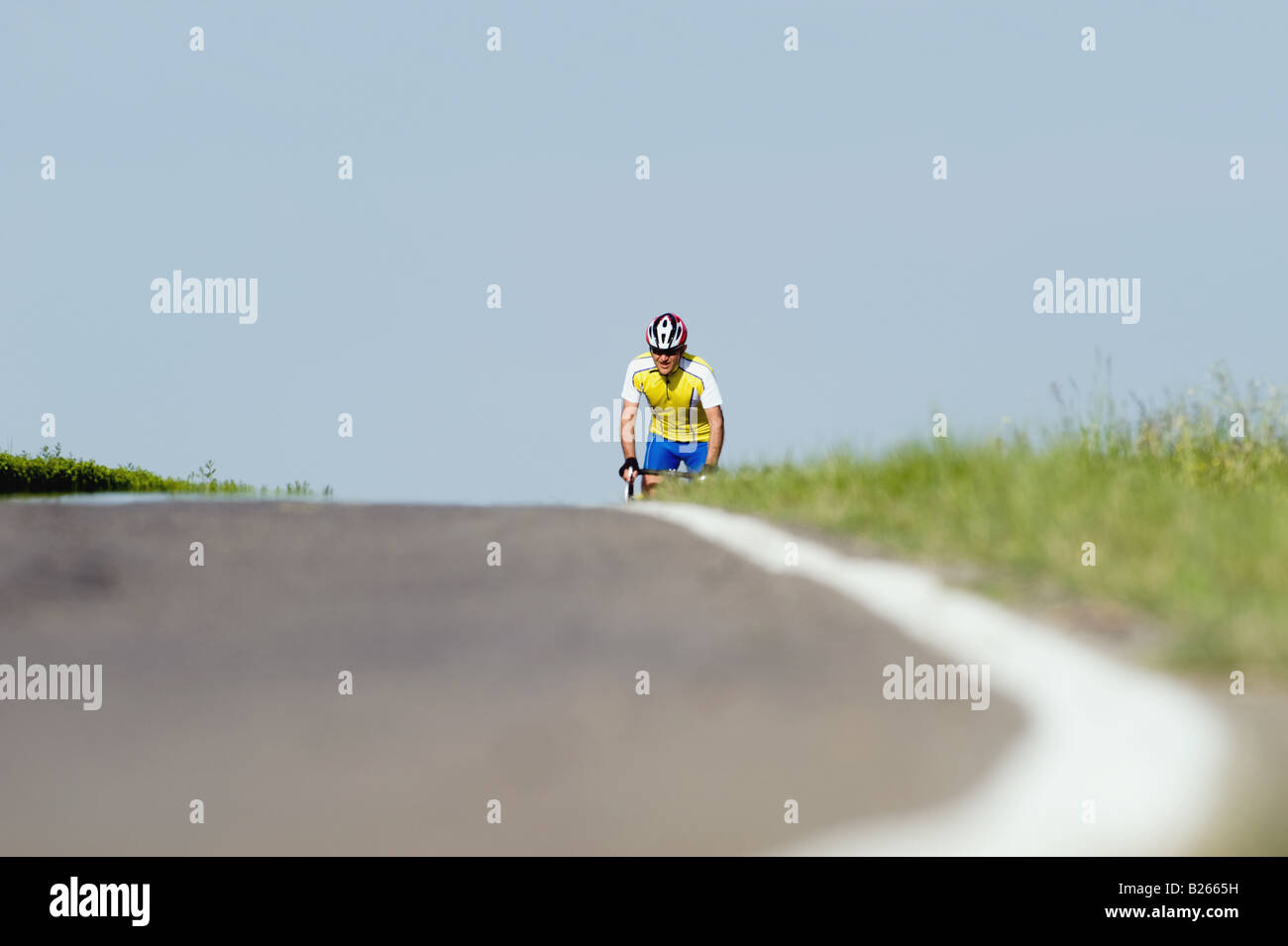 Cyclist riding bicycle, front view Stock Photo - Alamy