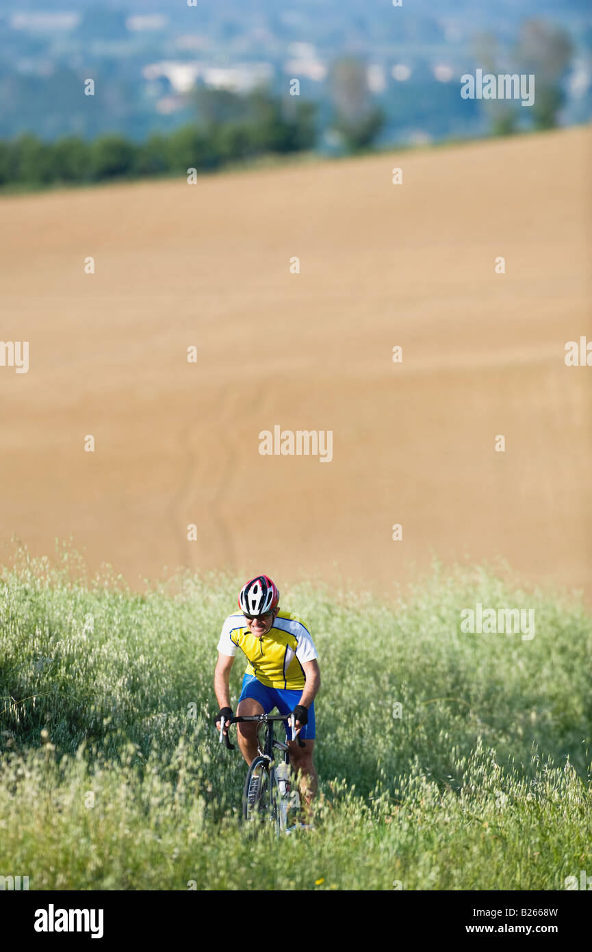 Cyclist riding bicycle, front view Stock Photo - Alamy