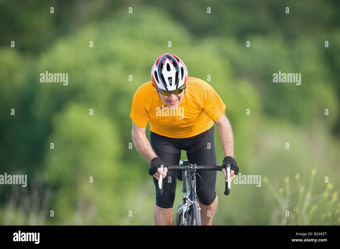 Cyclist riding bicycle, front, view Stock Photo - Alamy