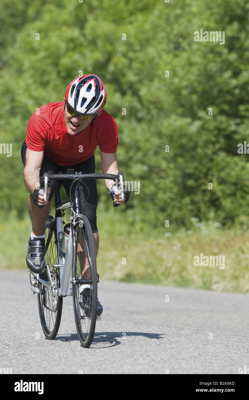 Front view of a man cycling on road Stock Photo - Alamy