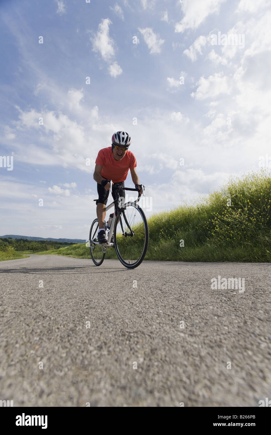 Front view of a man cycling on road Stock Photo - Alamy