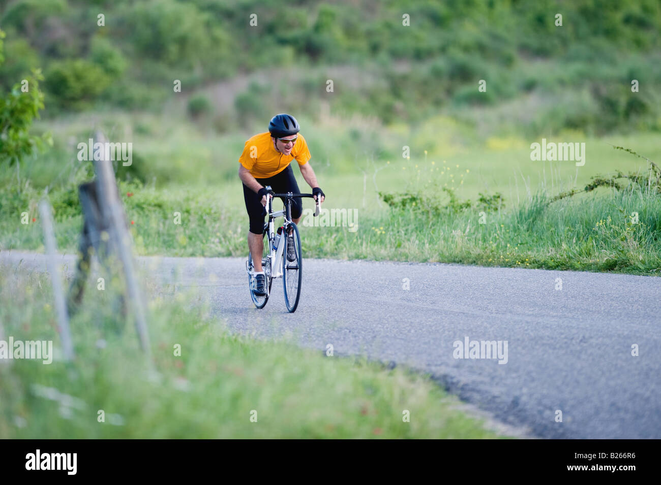 Front view of a man cycling on road Stock Photo - Alamy