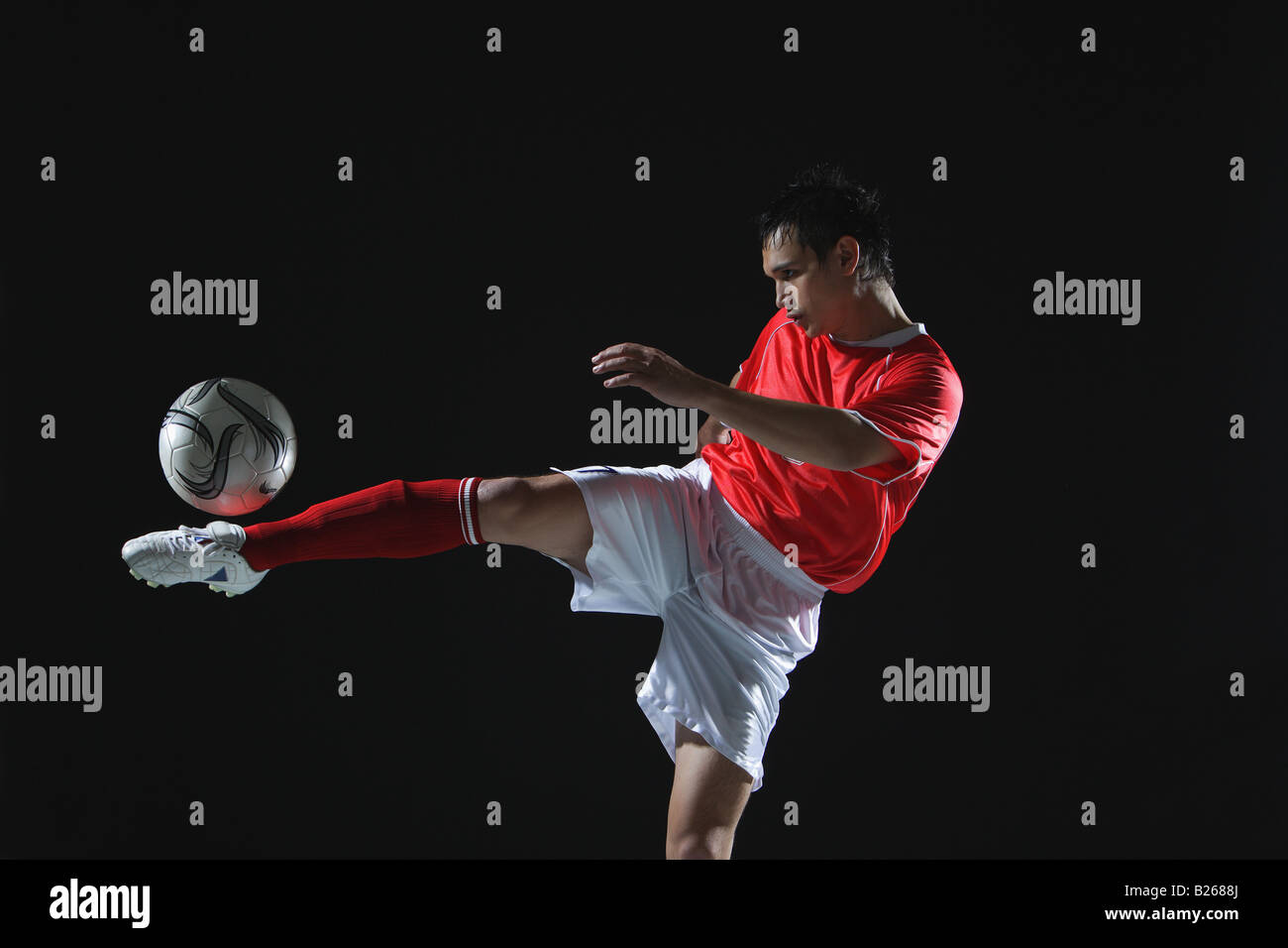 Man soccer player kicking foot hi-res stock photography and images - Alamy