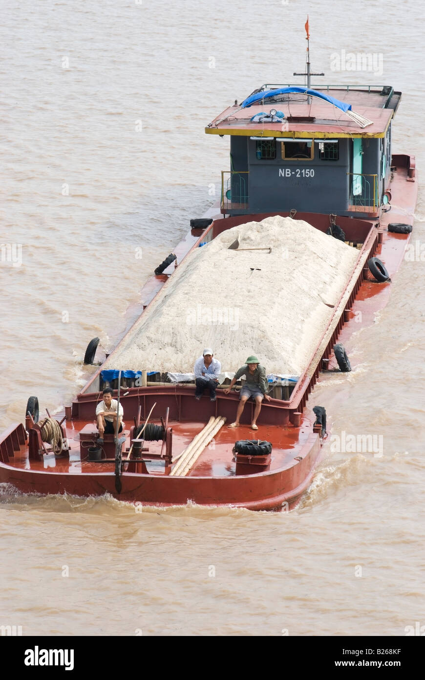 Cargo vessel transporting sand down the Red River through Hanoi in ...