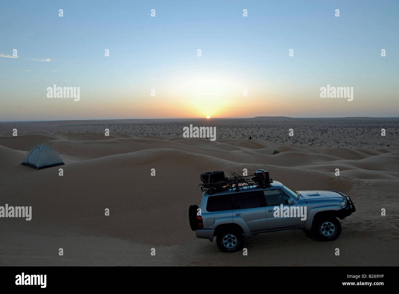 A 4x4 vehicle driving through sand dunes in the desert, 4x4 Sahara ...