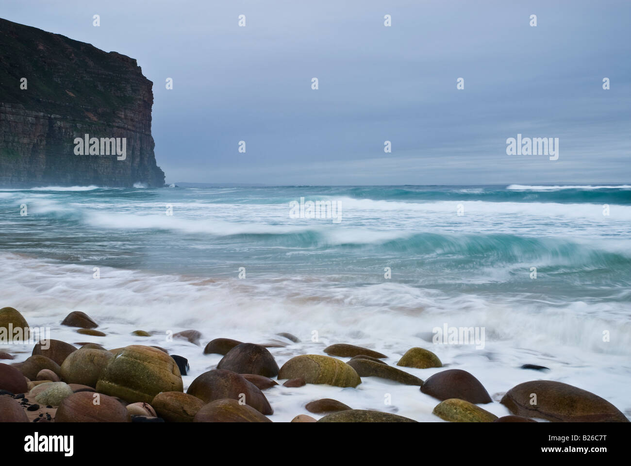 Waves crash along rocky beach at Rackwick bay on the island of Hoy ...