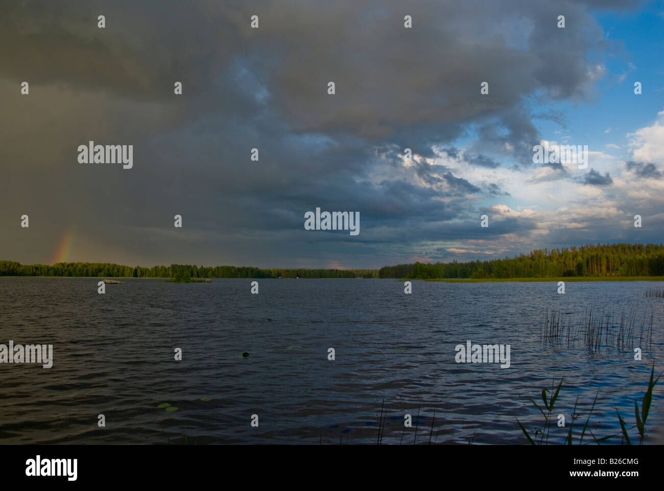 A passing storm creates a dramatic scene with dark clouds and rain ...