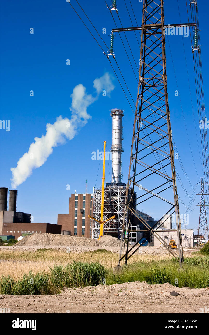 Construction of an industry with a big chimney on a clear blue sky ...