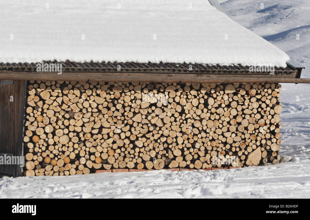 Stack of firewood under a snowcovered roof Stock Photo - Alamy