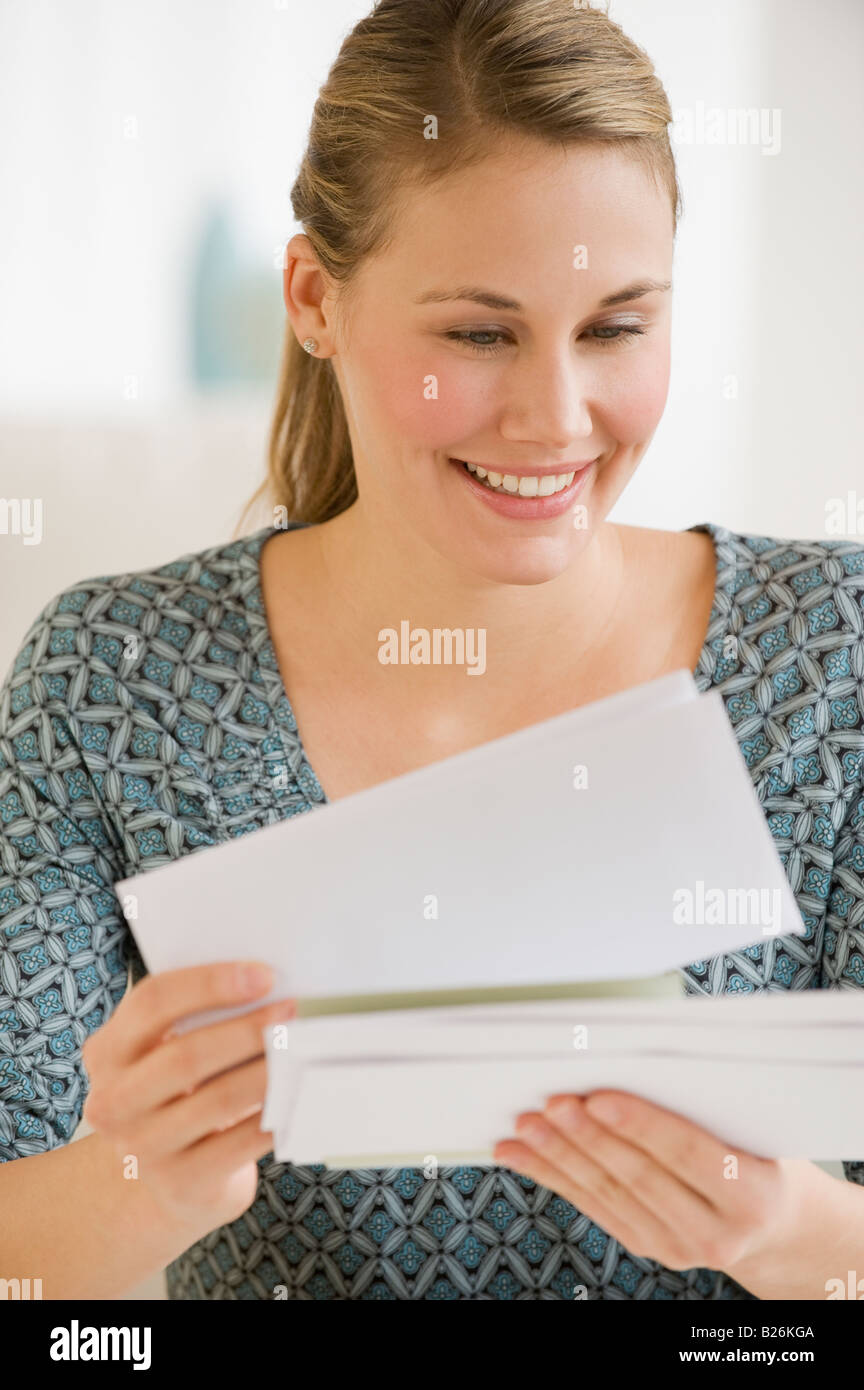 Woman looking at mail Stock Photo - Alamy