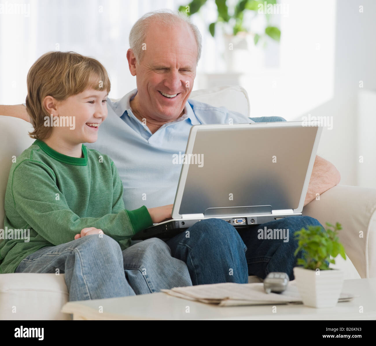 Grandson showing grandfather computer hi-res stock photography and ...
