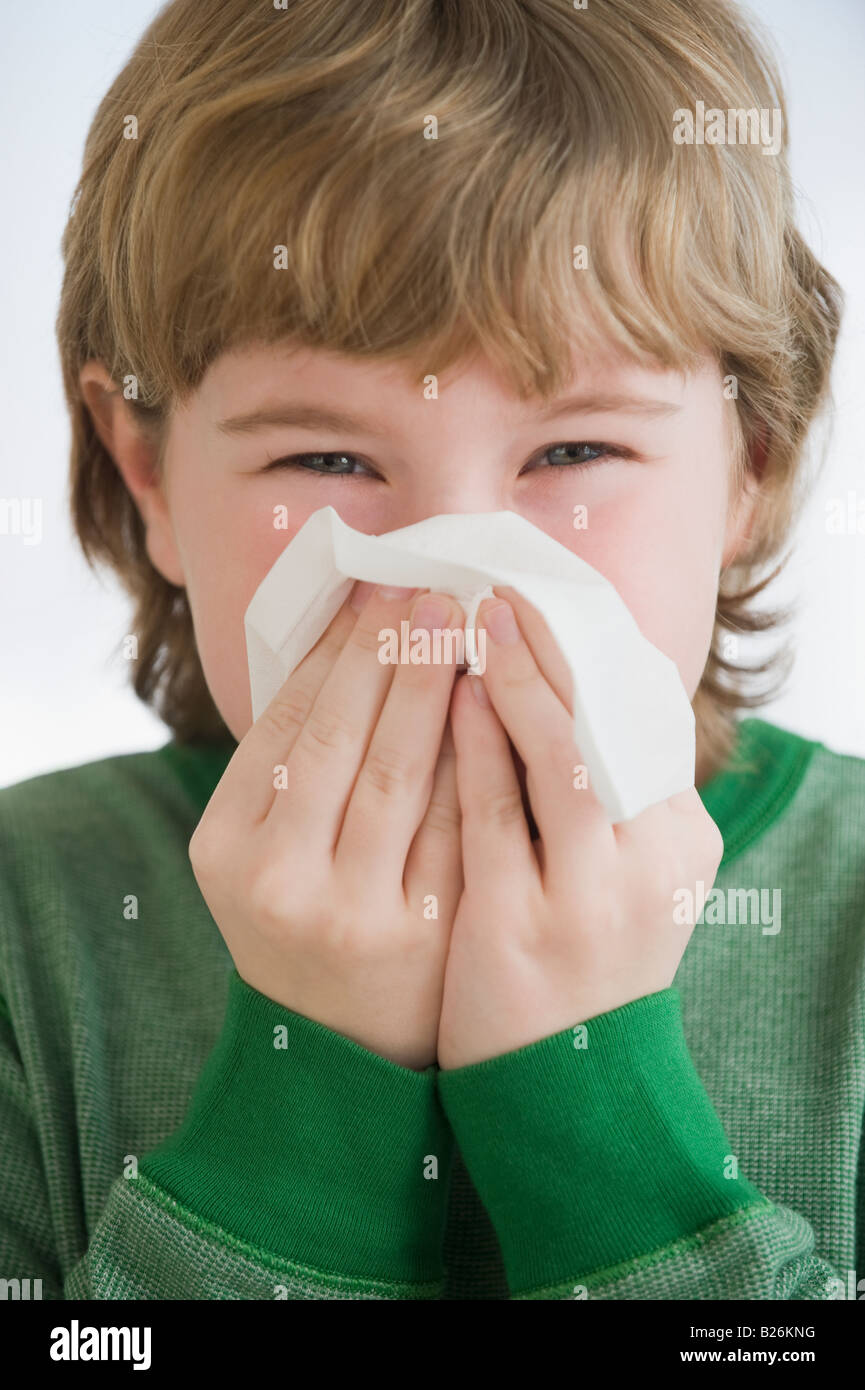 Boy blowing nose Stock Photo - Alamy