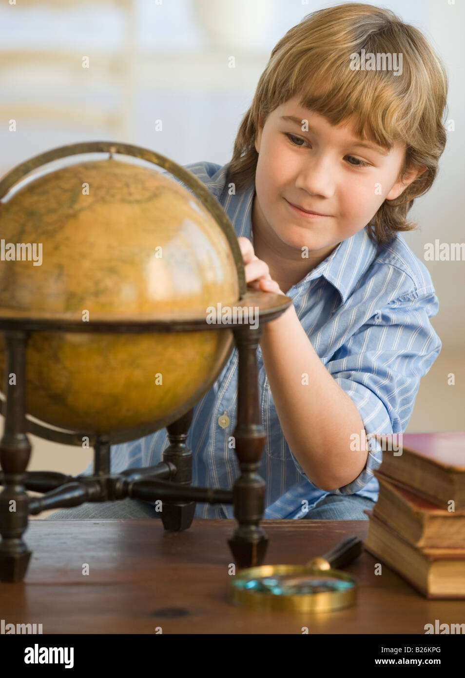 Boy looking at globe Stock Photo - Alamy