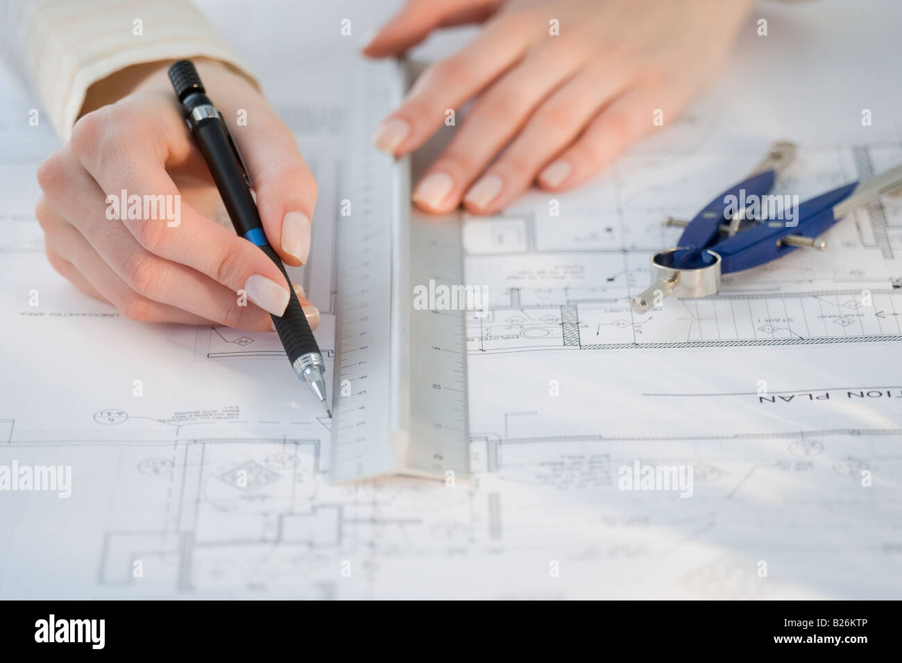 Architect drawing on blueprints Stock Photo - Alamy