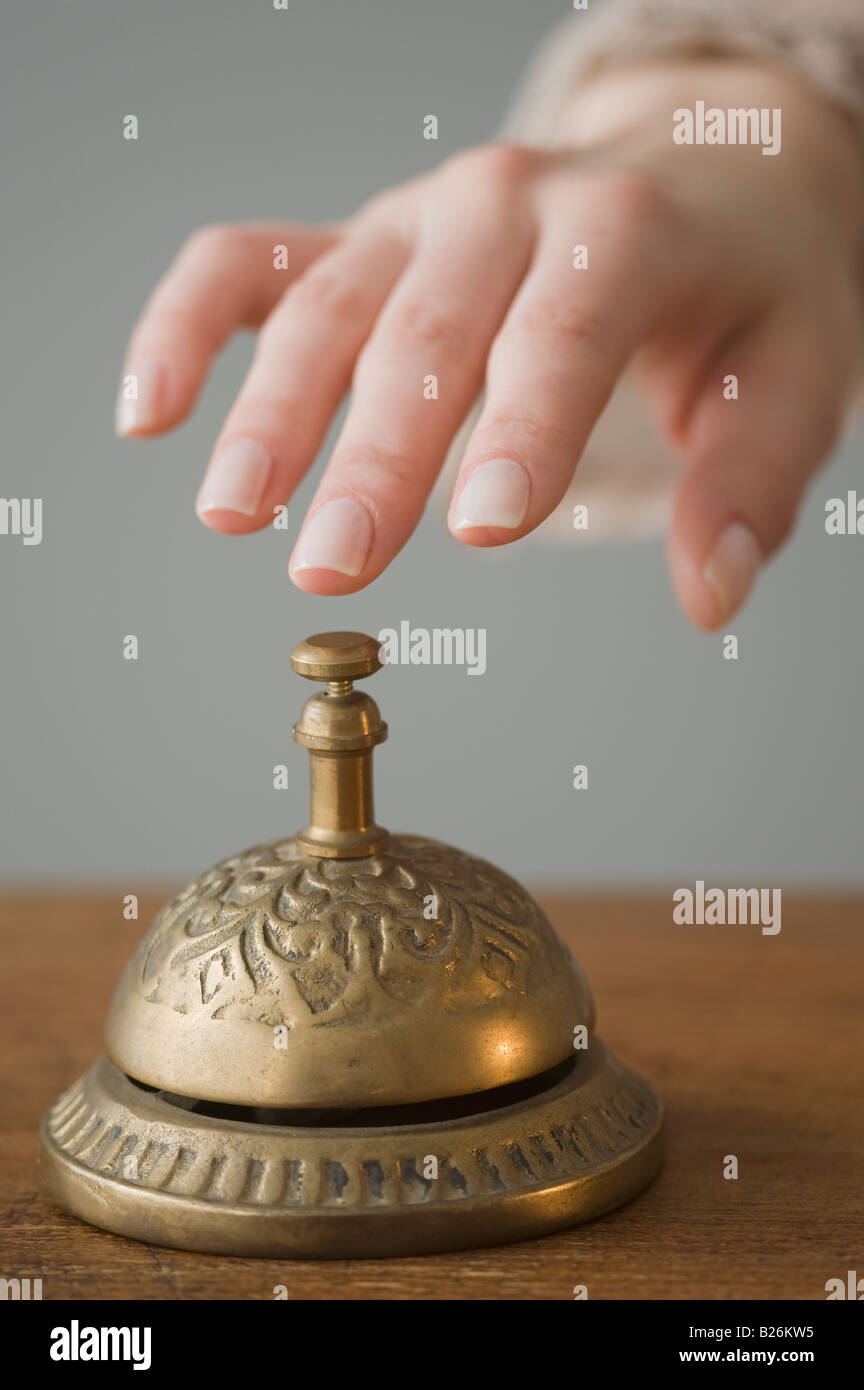 Woman ringing service bell Stock Photo - Alamy