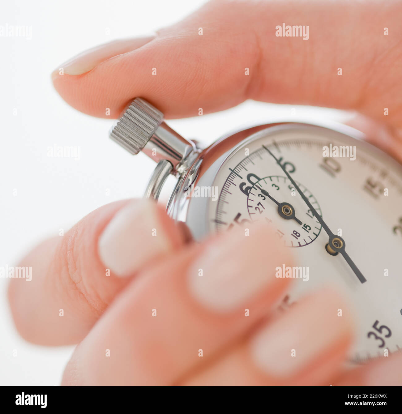 Woman holding stopwatch Stock Photo - Alamy
