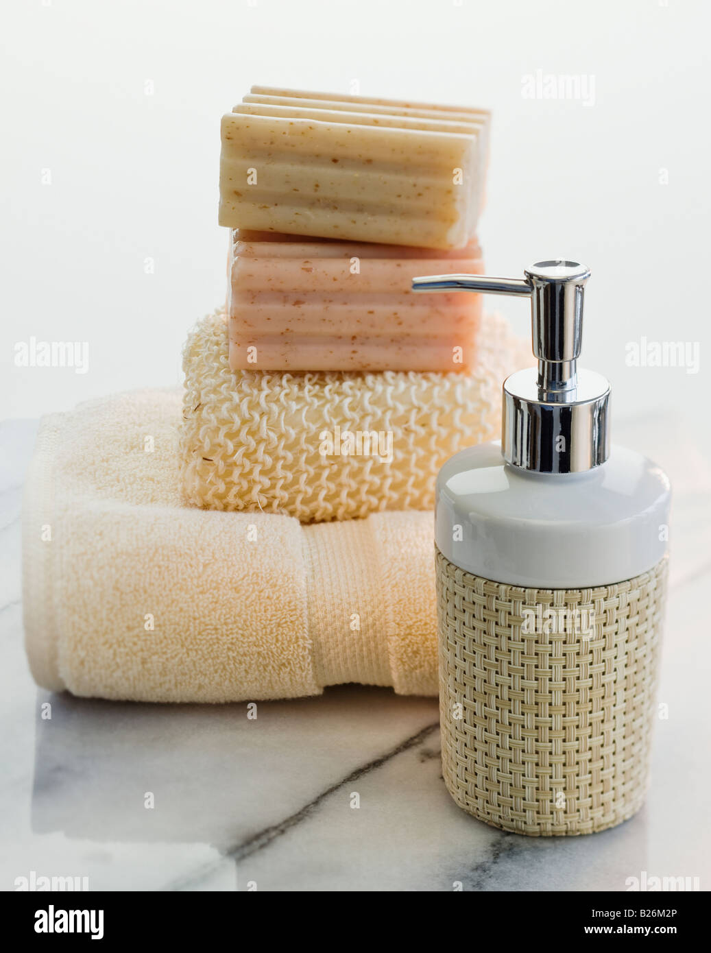 Stack of soap and towels next to lotion Stock Photo - Alamy
