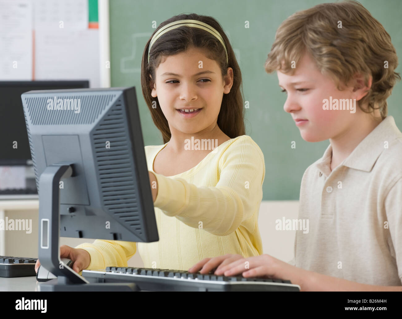 Multi-ethnic school children looking at computers Stock Photo - Alamy