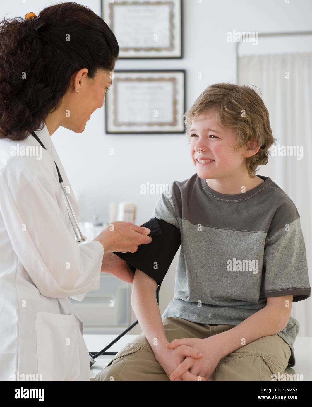 Hispanic female doctor taking child’s blood pressure Stock Photo - Alamy