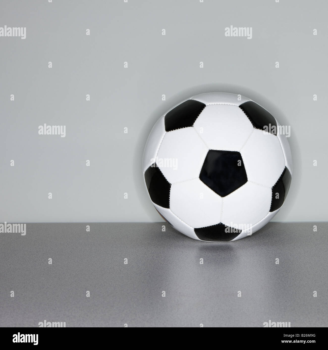 Soccer ball next to wall Stock Photo - Alamy