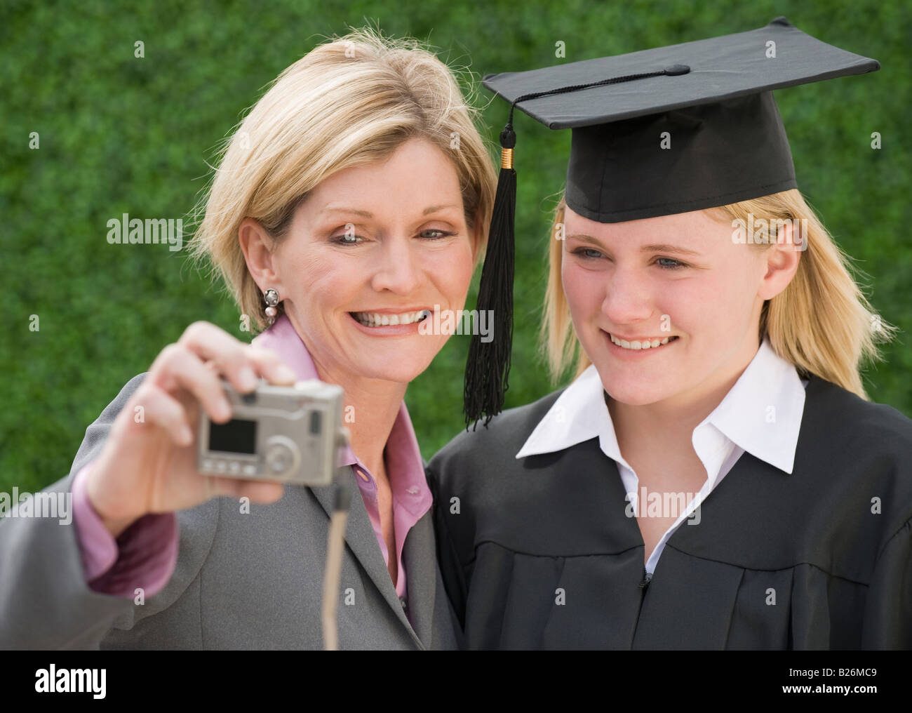 Mother and graduate daughter taking own photograph Stock Photo - Alamy