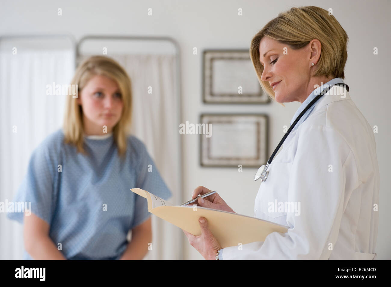 Female doctor reading chart Stock Photo - Alamy