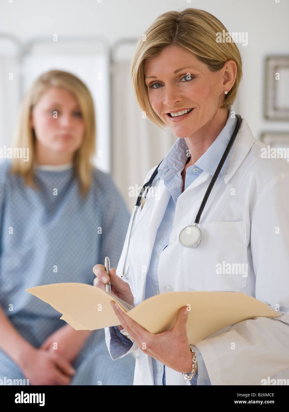 Female doctor holding chart Stock Photo - Alamy