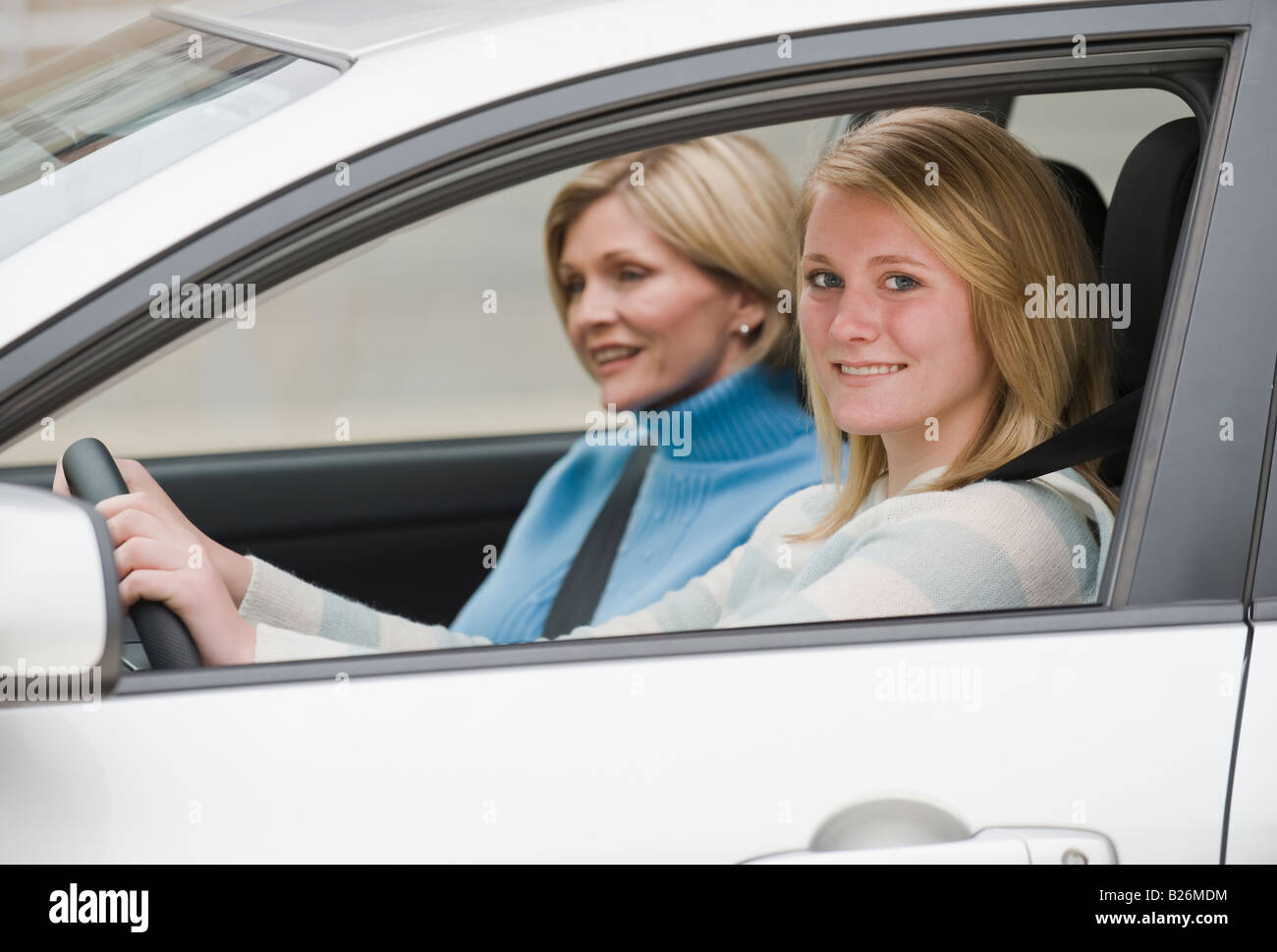 Teenaged girl driving with mother Stock Photo - Alamy