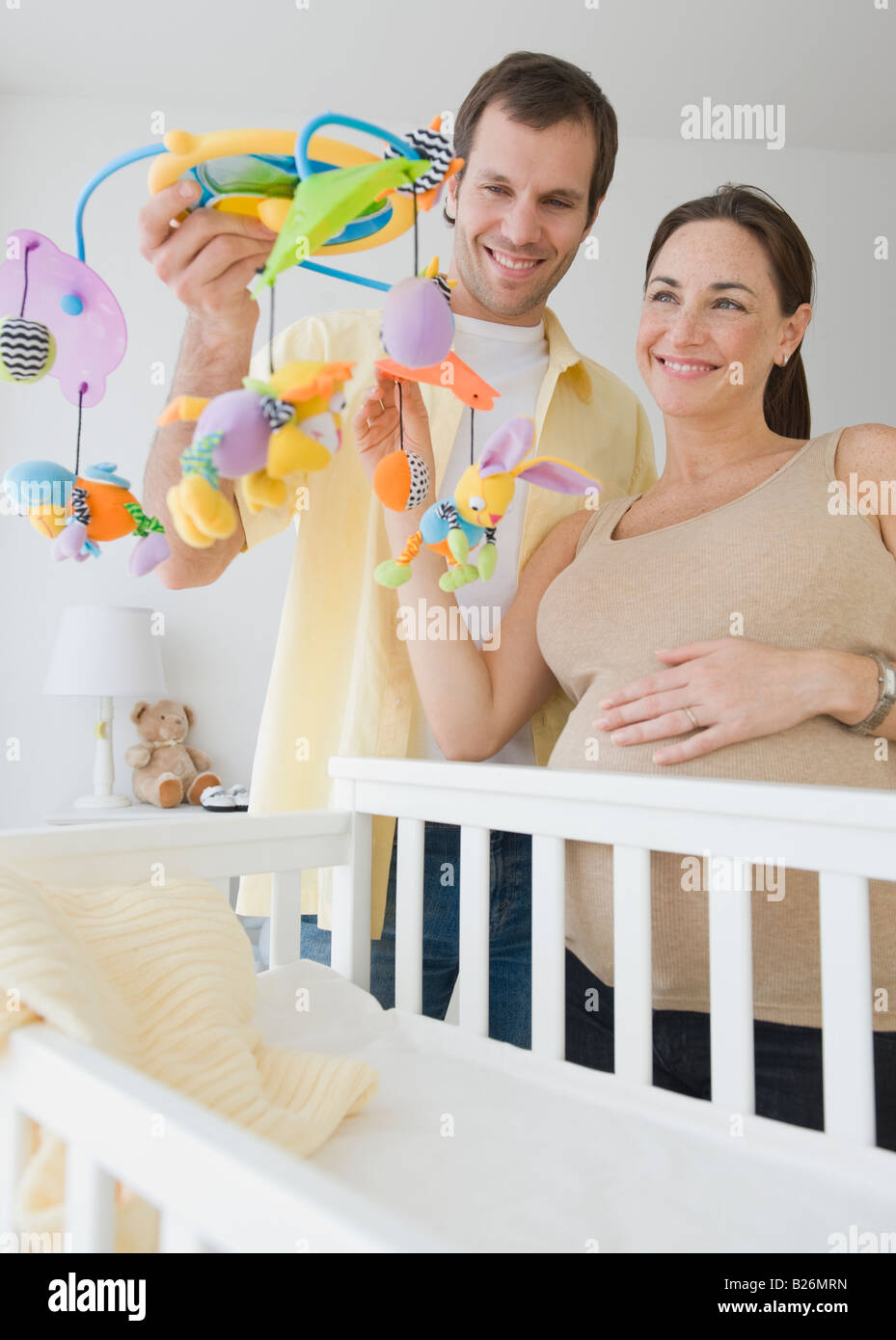 Couple standing over crib hi-res stock photography and images - Alamy