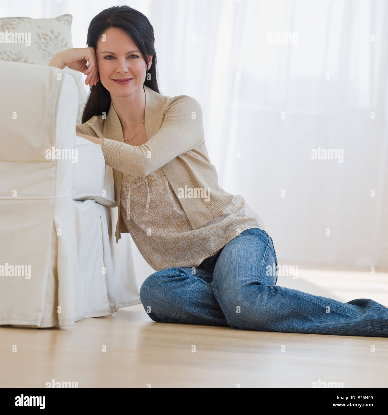 Woman sitting on floor Stock Photo - Alamy