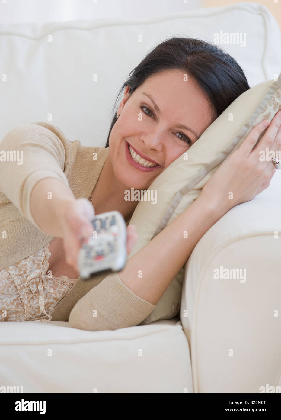 Woman pointing remote control Stock Photo - Alamy