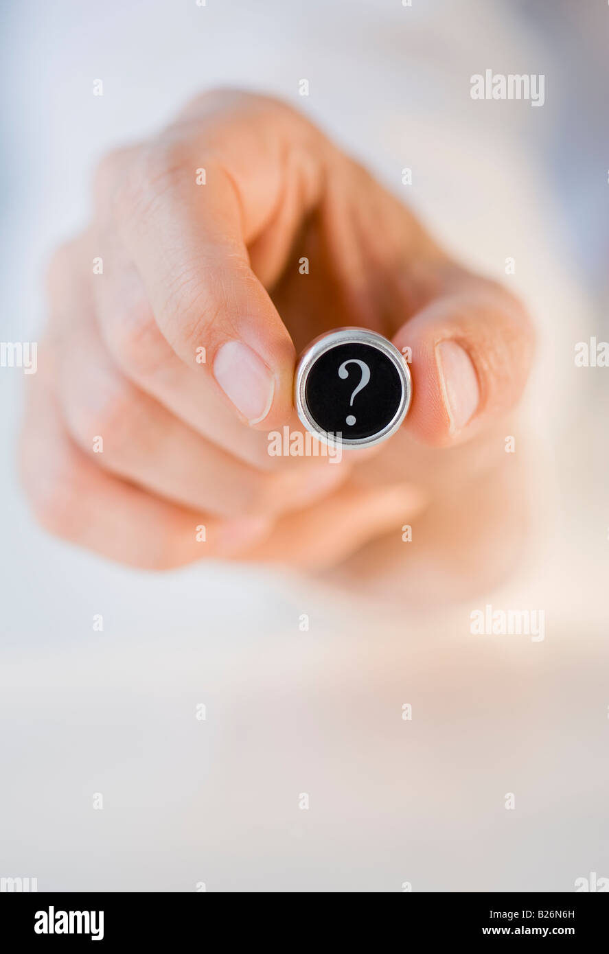 Man holding question mark Stock Photo - Alamy